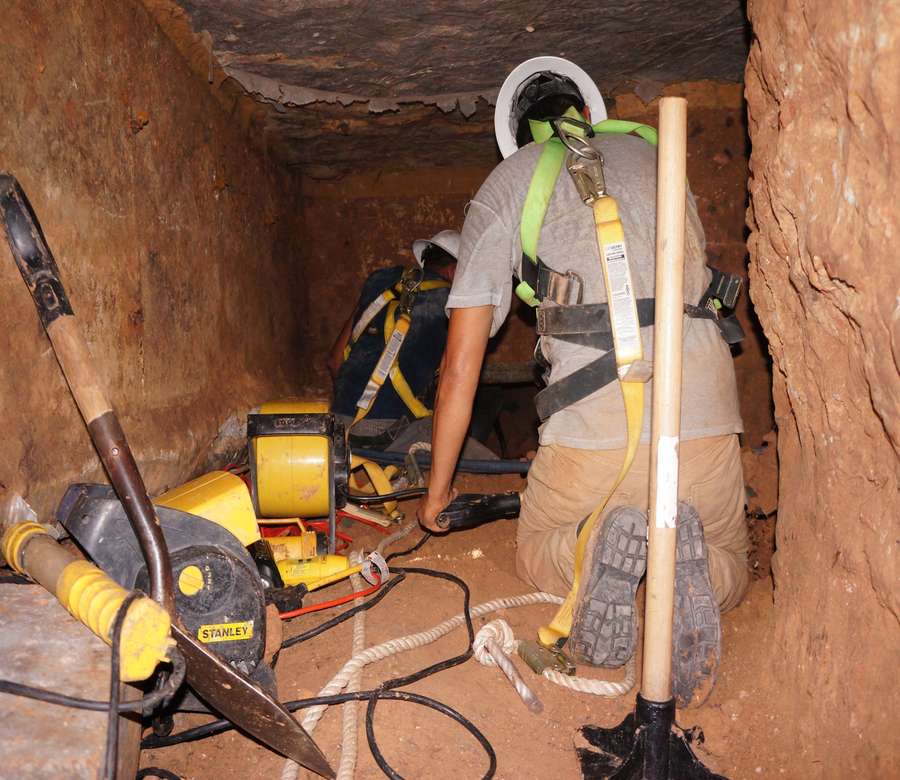 Tunnel or excavate under concrete slab